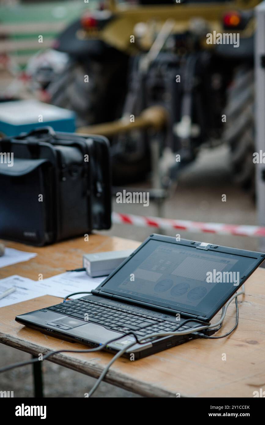 Laptop analyzing tractor data, with a technical setup on-site Stock ...