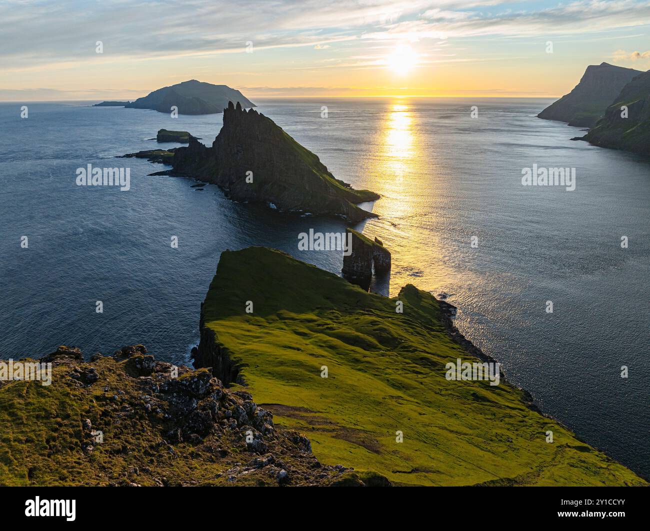 Sunset over cliffs in the blue ocean, Faroe Islands Stock Photo - Alamy