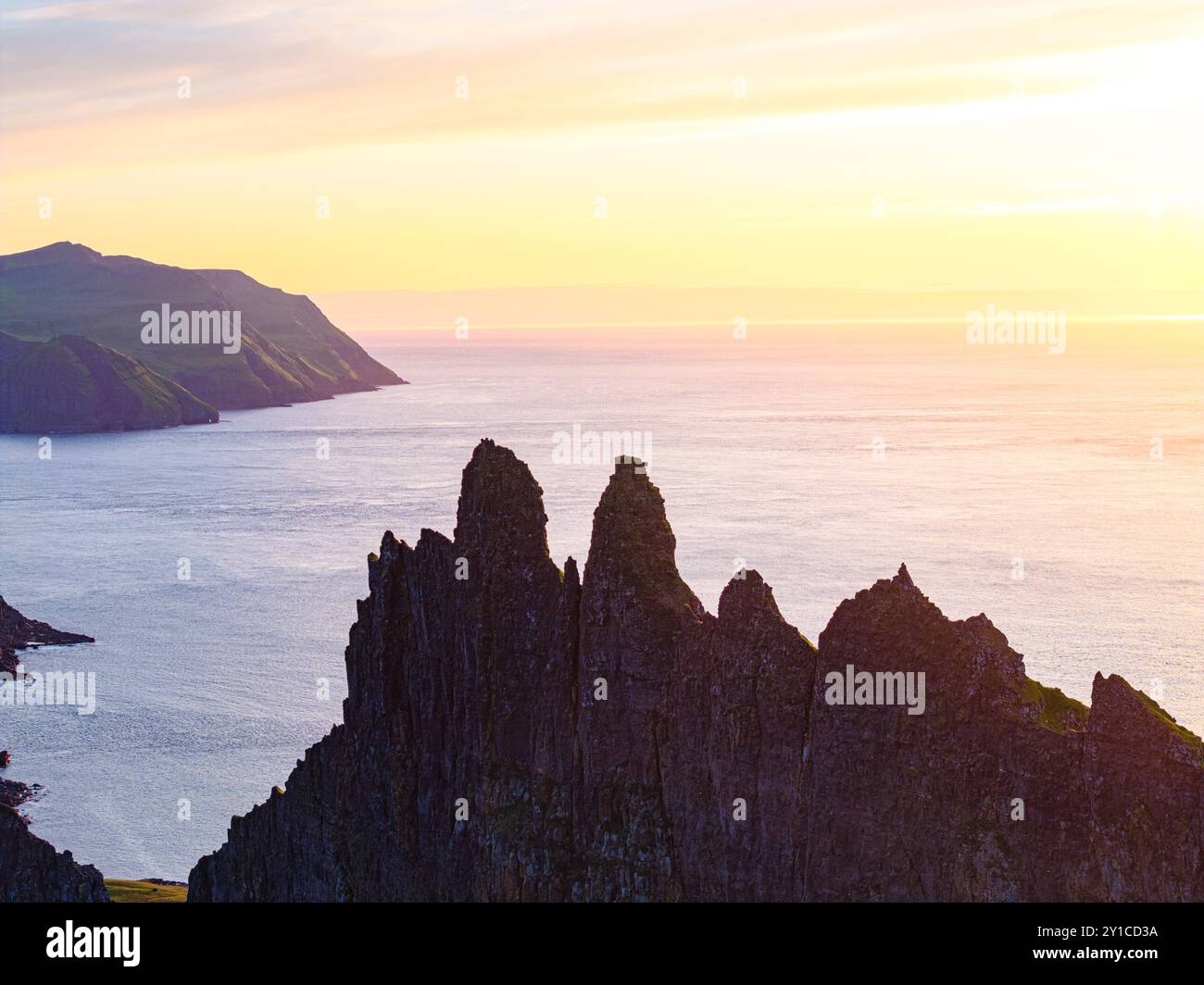 Sharp rock pinnacles of cliffs at sunset Stock Photo - Alamy