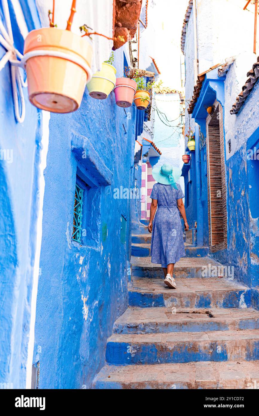 Charming woman on blue steps of Chefchaouen Stock Photo - Alamy