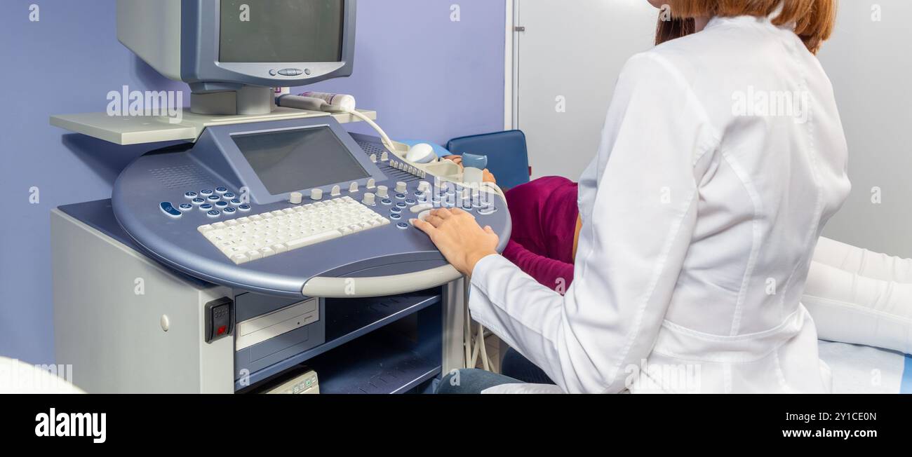 The doctor performs an ultrasound diagnosis of the abdominal cavity of ...