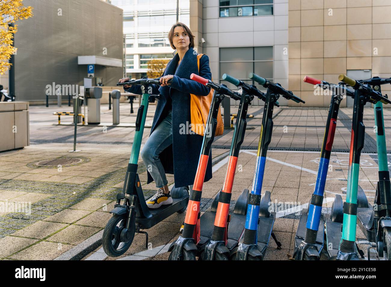 Woman commuting on scooter hi-res stock photography and images - Alamy