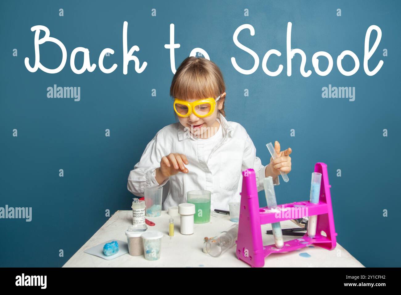Cute intelligent kid with welcome back to school lettering on blue ...