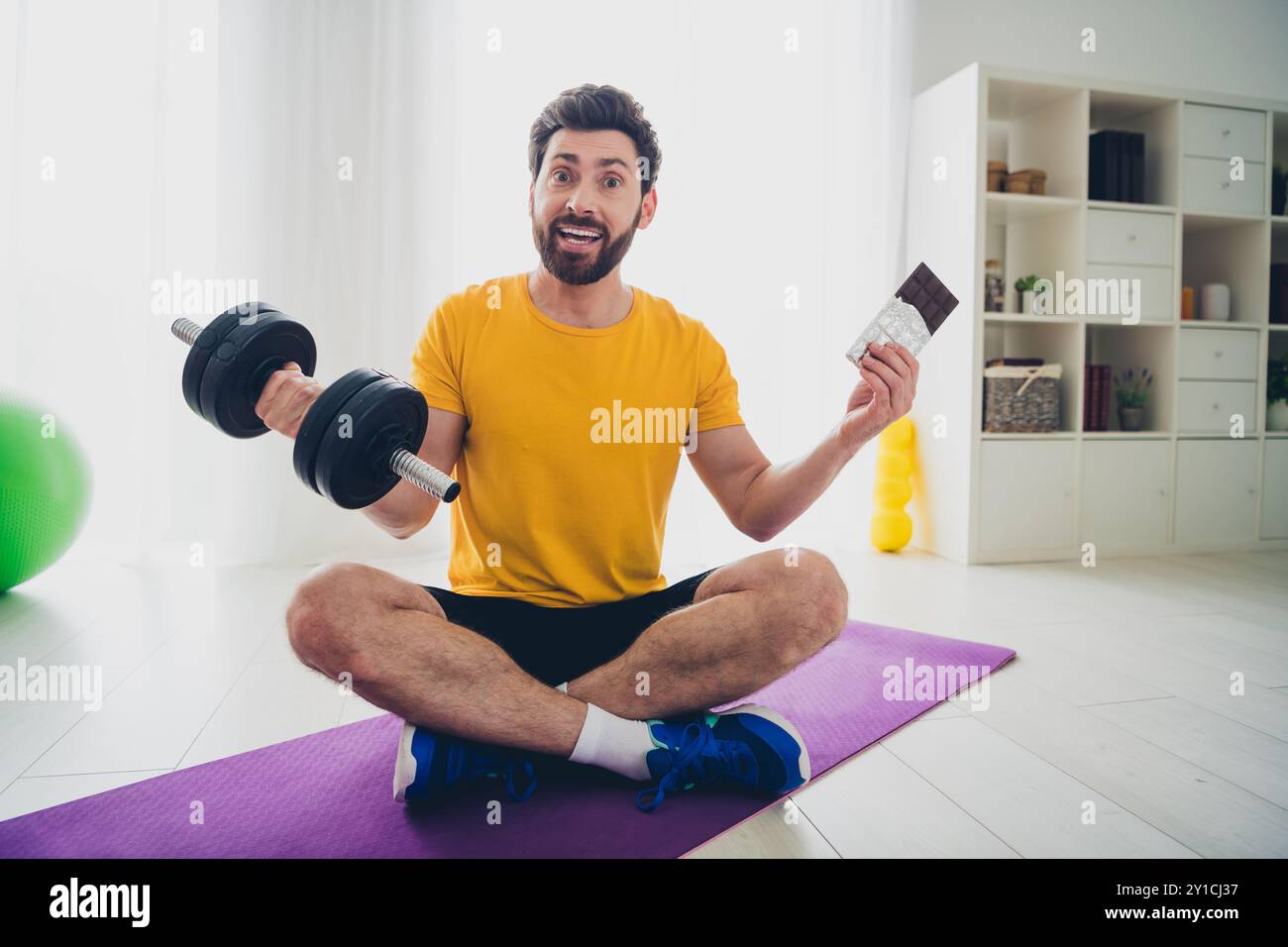 Photo of attractive nice strong man doing physical exercises raising ...
