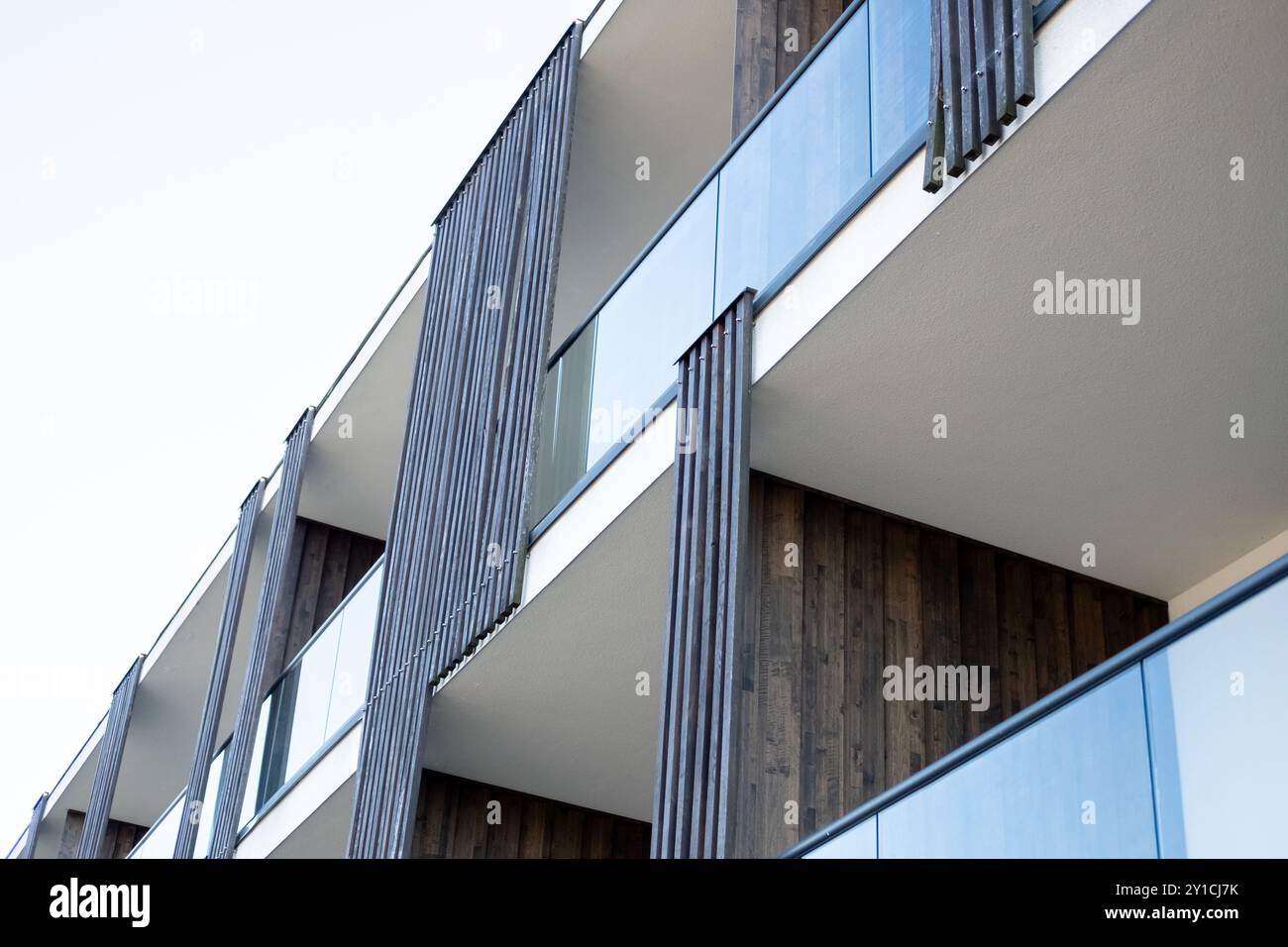 Low-angle view of a contemporary residential building featuring wooden ...