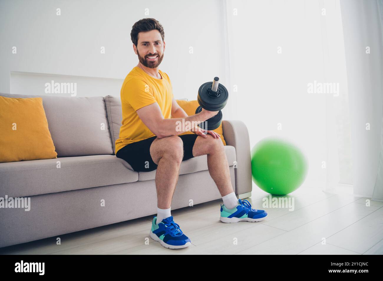 Photo of attractive powerful man doing physical exercises heavy ...