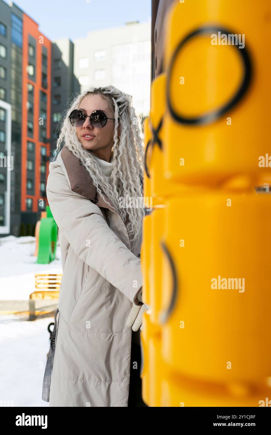 Woman Standing Next to Yellow Pole Stock Photo - Alamy