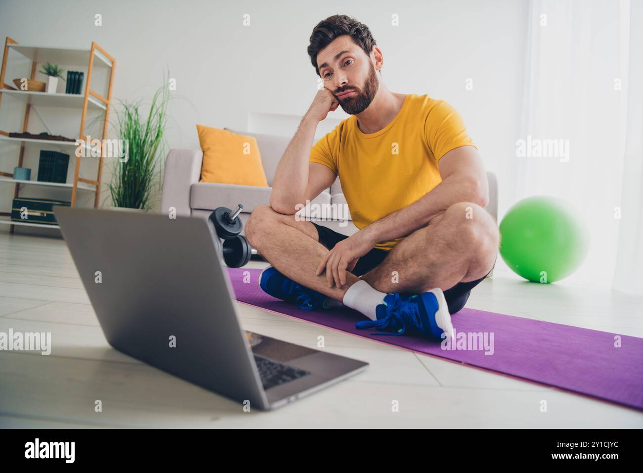 Photo of attractive athletic strong man listen watch video exercises ...