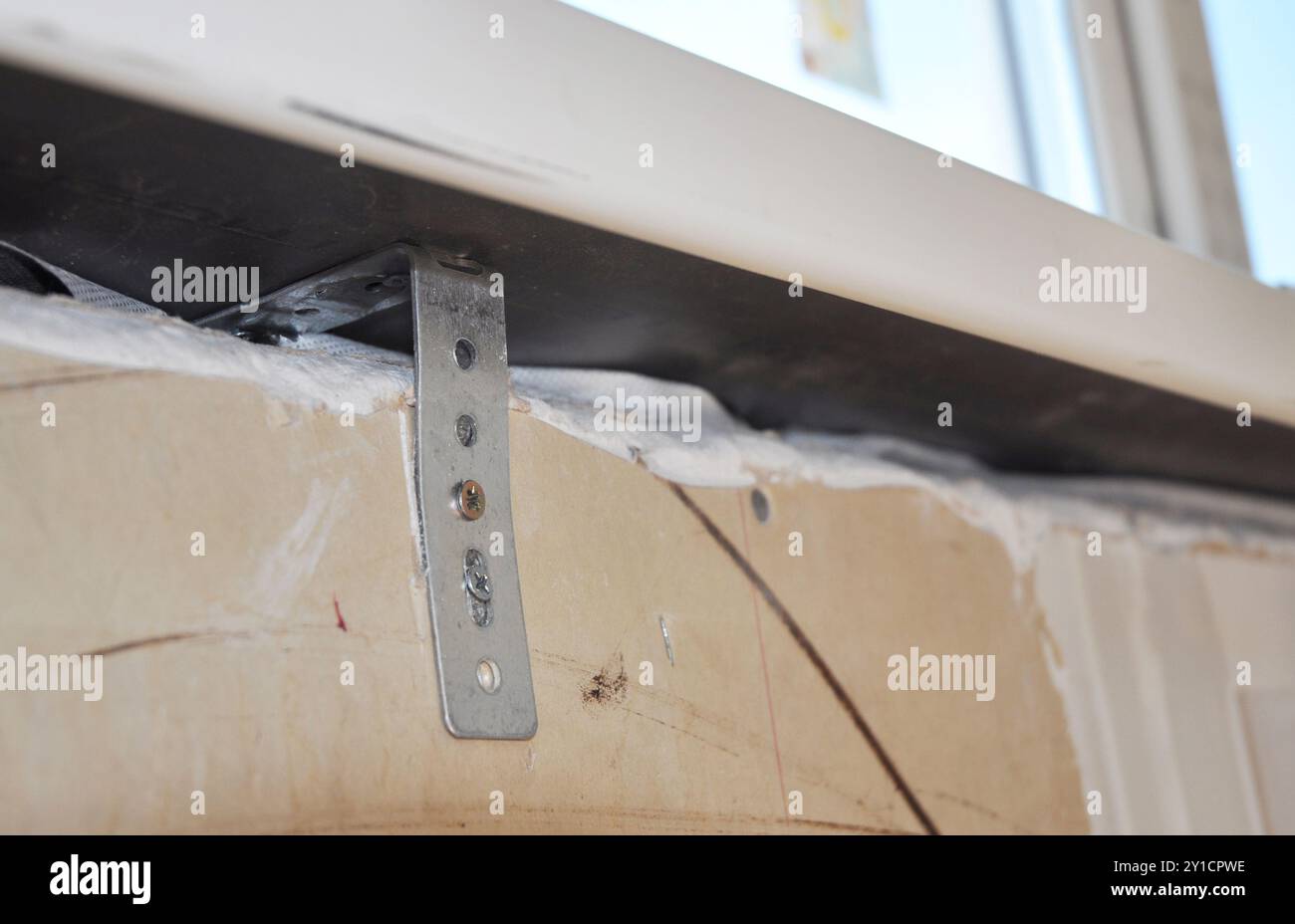 Installing a window sill in a new house. Close up on window sill holder ...