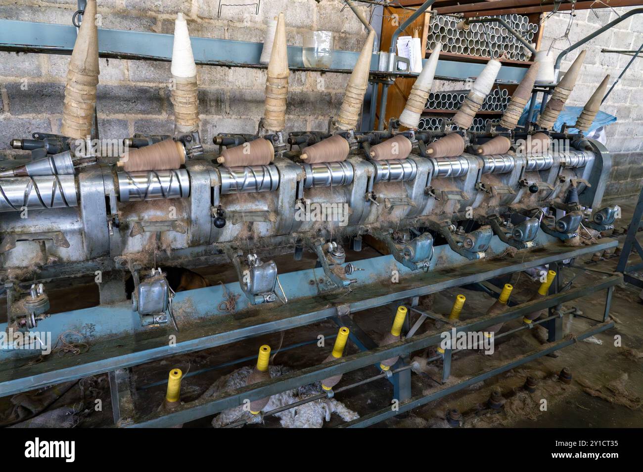 Machinery to spin small spools of thread or yarn into larger spools ...