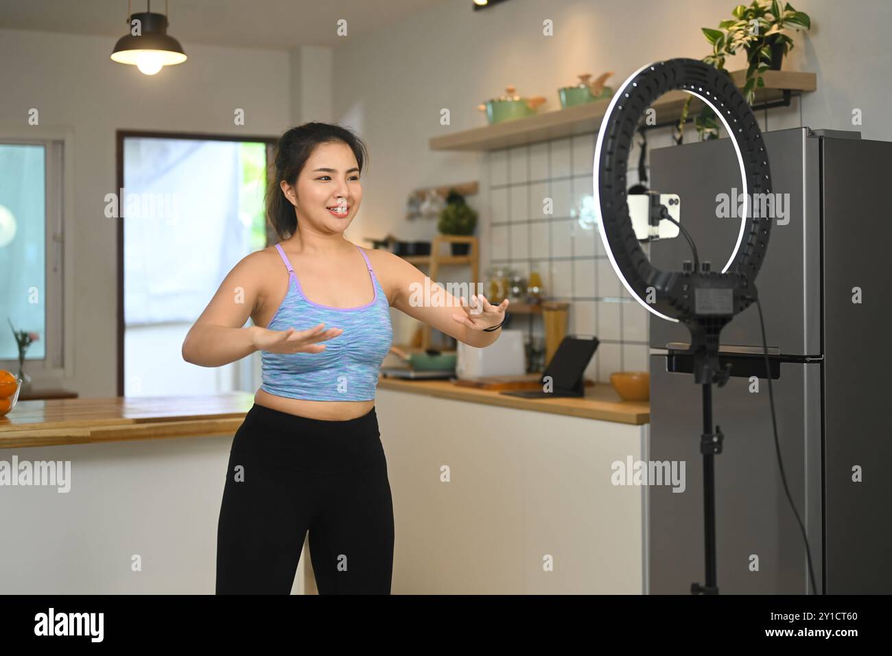 Female fitness vlogger making online workout videos, tutorials or ...