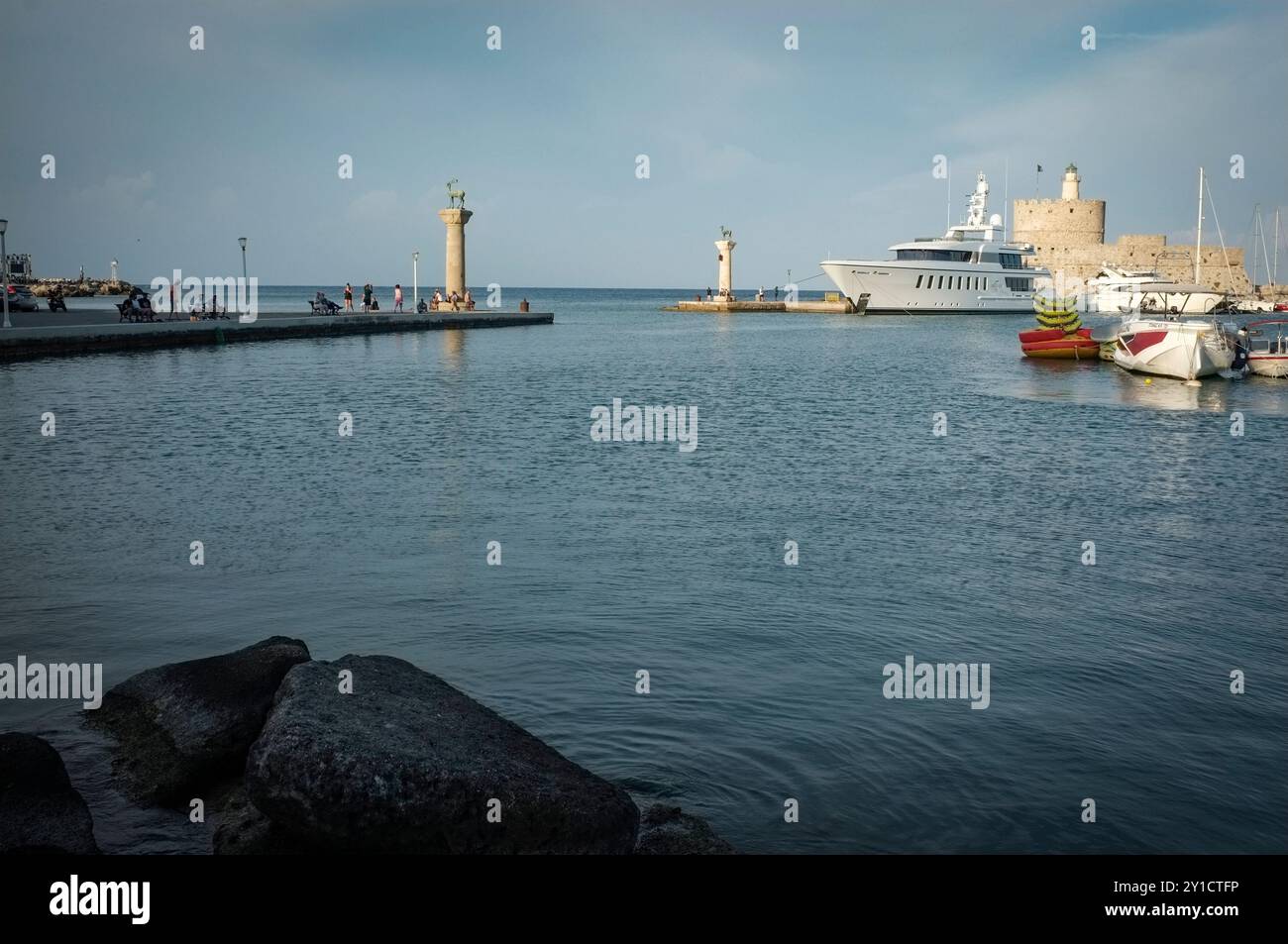 Entrance to Mandraki Harbour & port on the Greek island of Rhodes ...