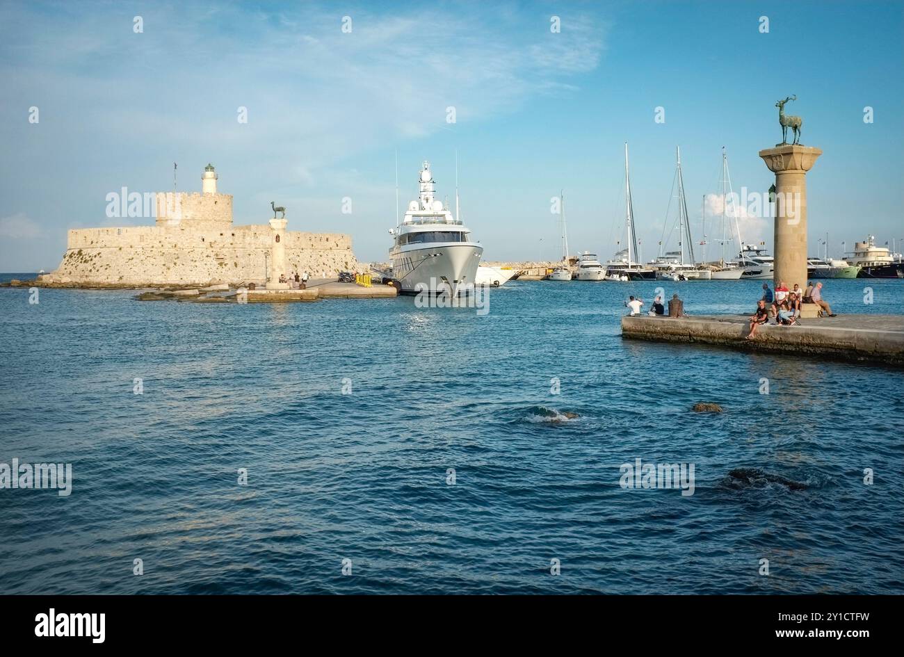 Entrance to Mandraki Harbour & port on the Greek island of Rhodes ...
