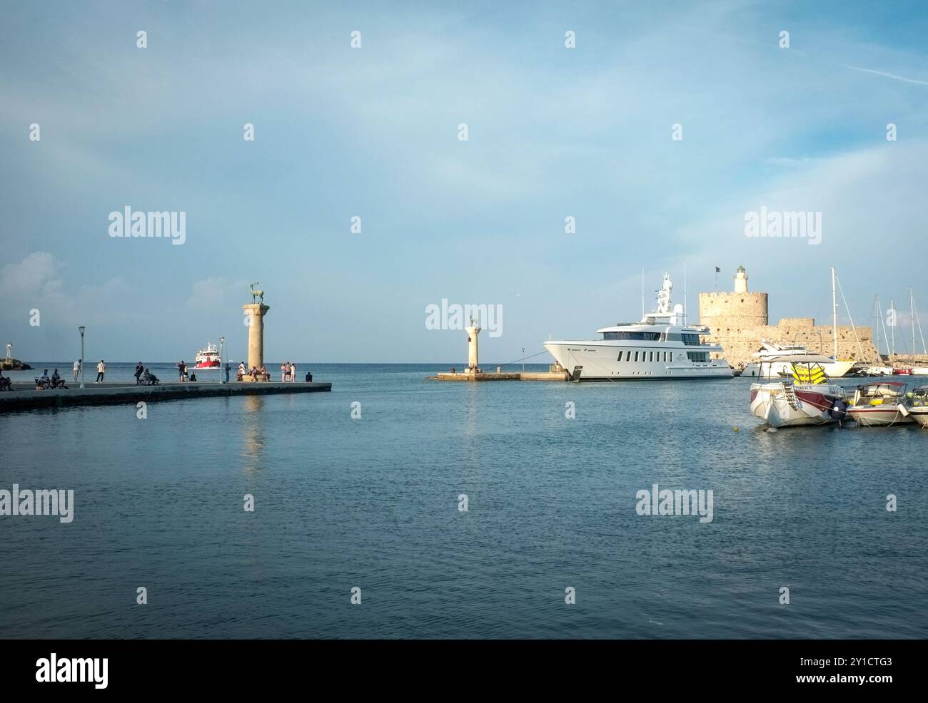 Entrance to Mandraki Harbour & port on the Greek island of Rhodes ...