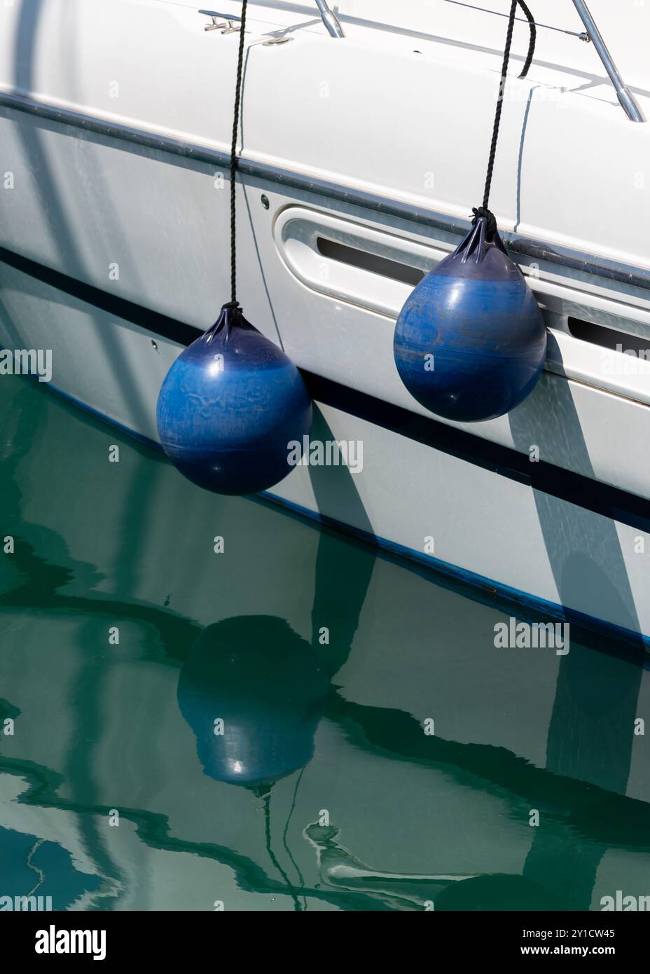 Fender buoy hang on boat side, anti collision protection Stock Photo ...