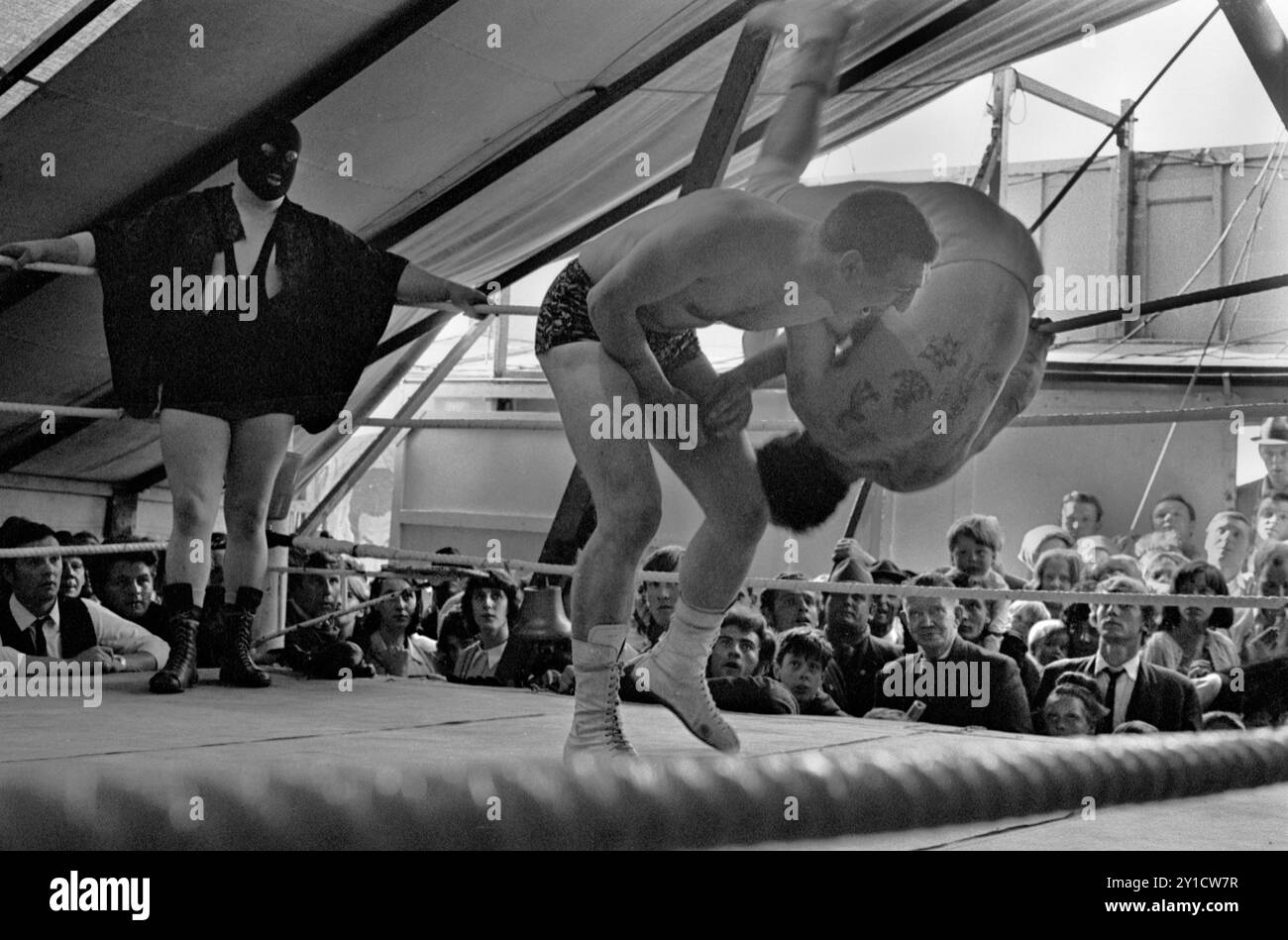Tag wrestling in Pat McKeowen's fairground travellers boxing booth show ...