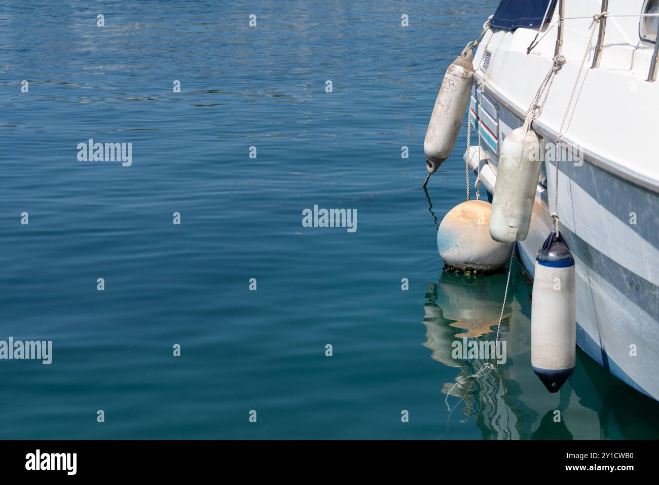 Fender buoy hang on boat side, anti collision protection Stock Photo ...