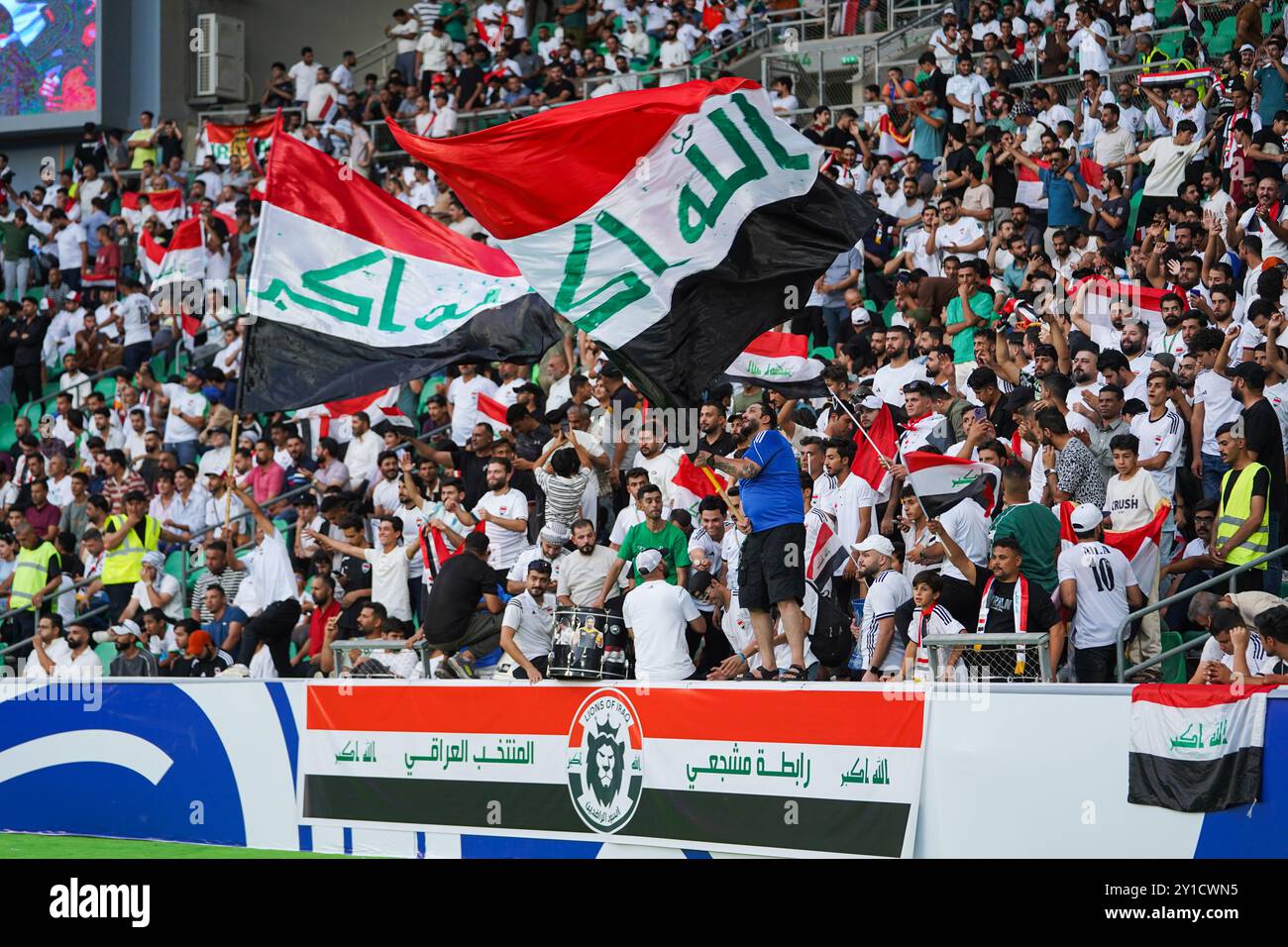 Basra, Iraq. 05th Sep, 2024. Iraqi fans hold flags during the 2026 FIFA ...
