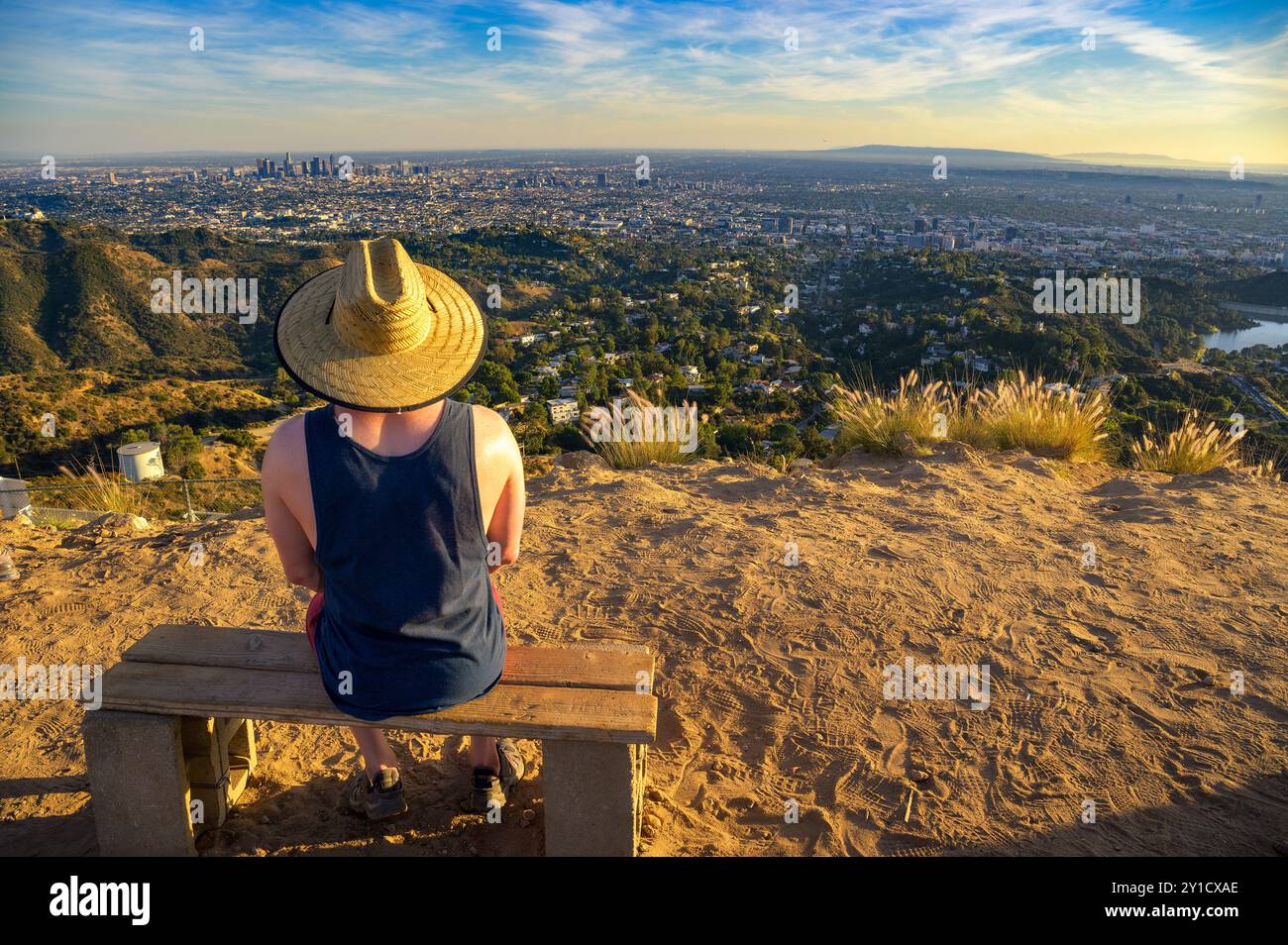 Tourist overlooking the Los Angeles skyline from Mount Lee at sunset ...