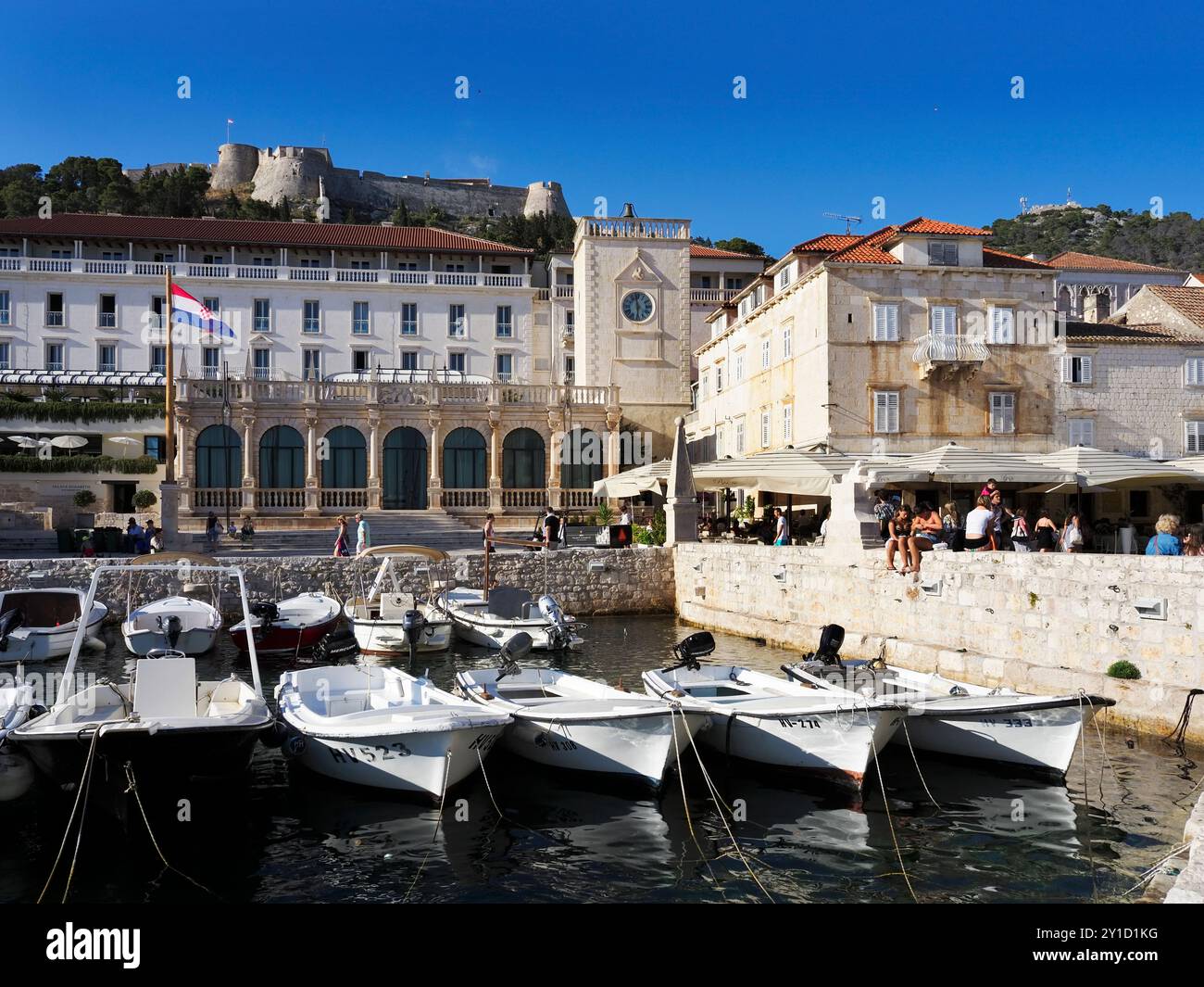 Port of Hvar harbour with loggia and clock tower behind and city ...