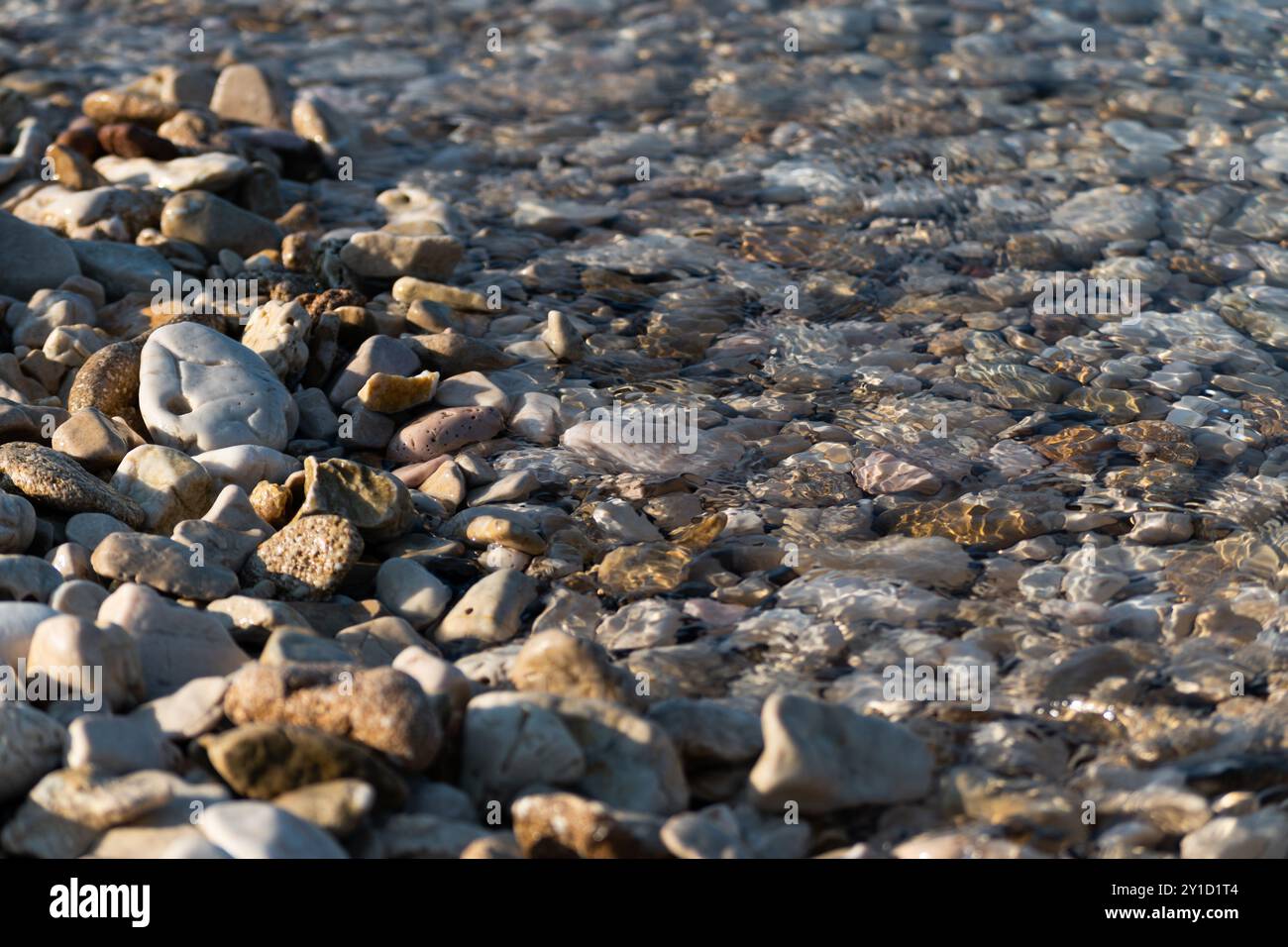 Small wave splashes over pebble on beach Stock Photo - Alamy