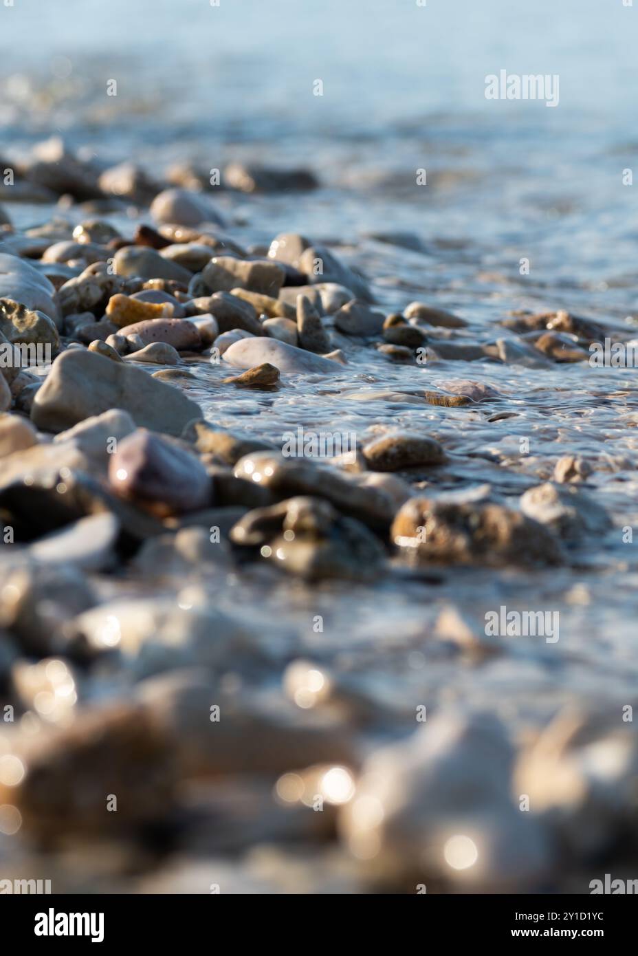 Small wave splashes over pebble on beach Stock Photo - Alamy
