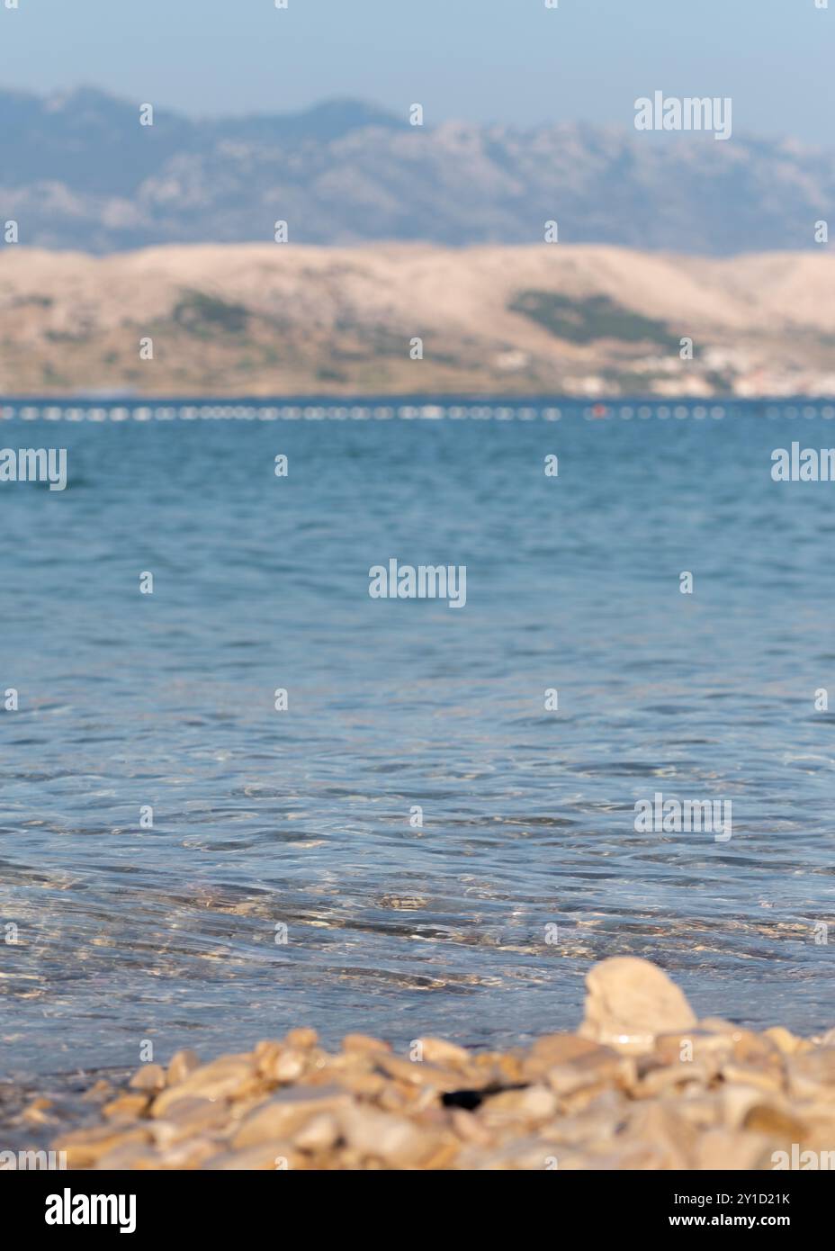 Rippling sea surface near shore, beach stones out of focus Stock Photo ...