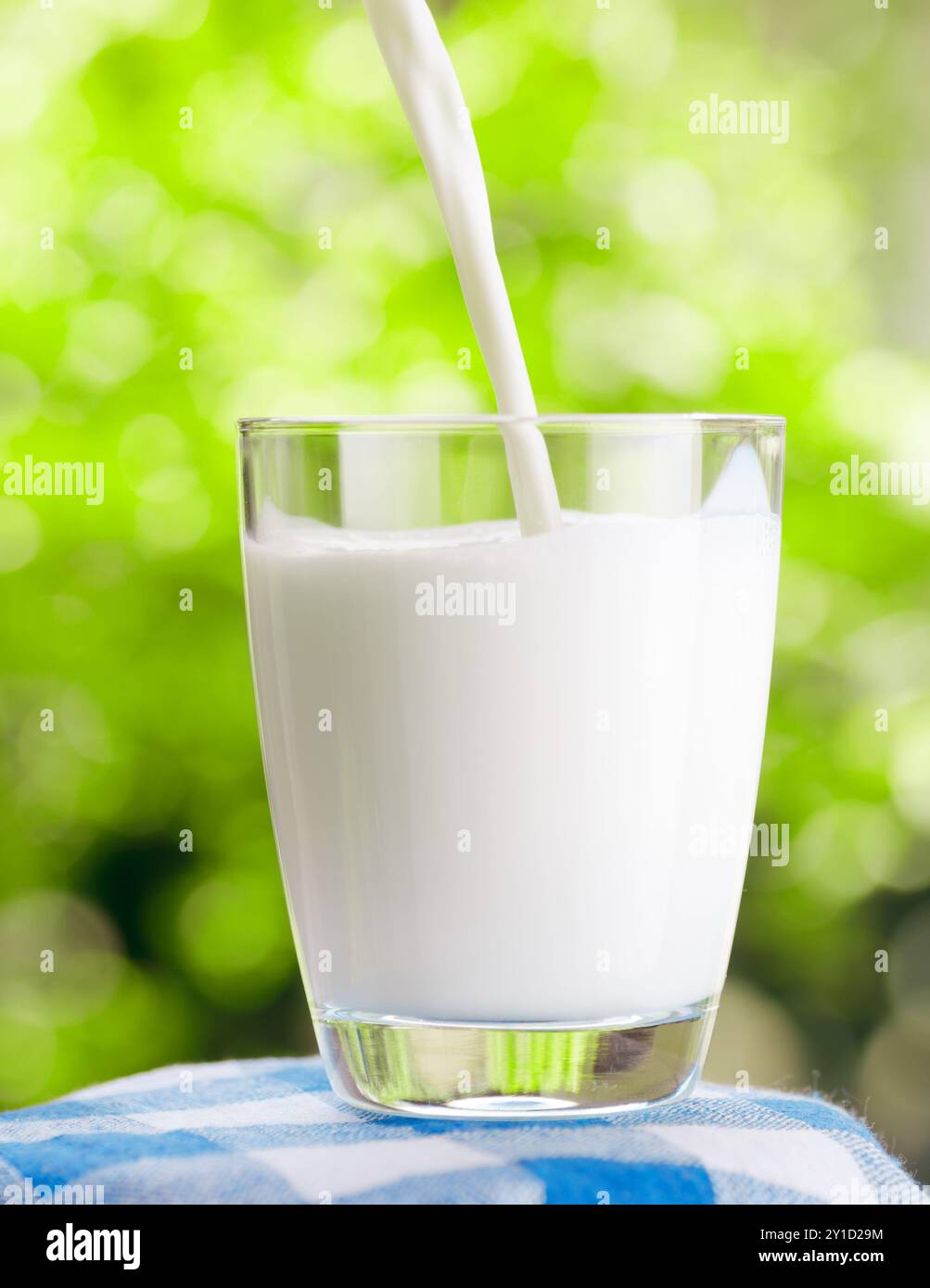 Glass of milk on nature background Stock Photo - Alamy