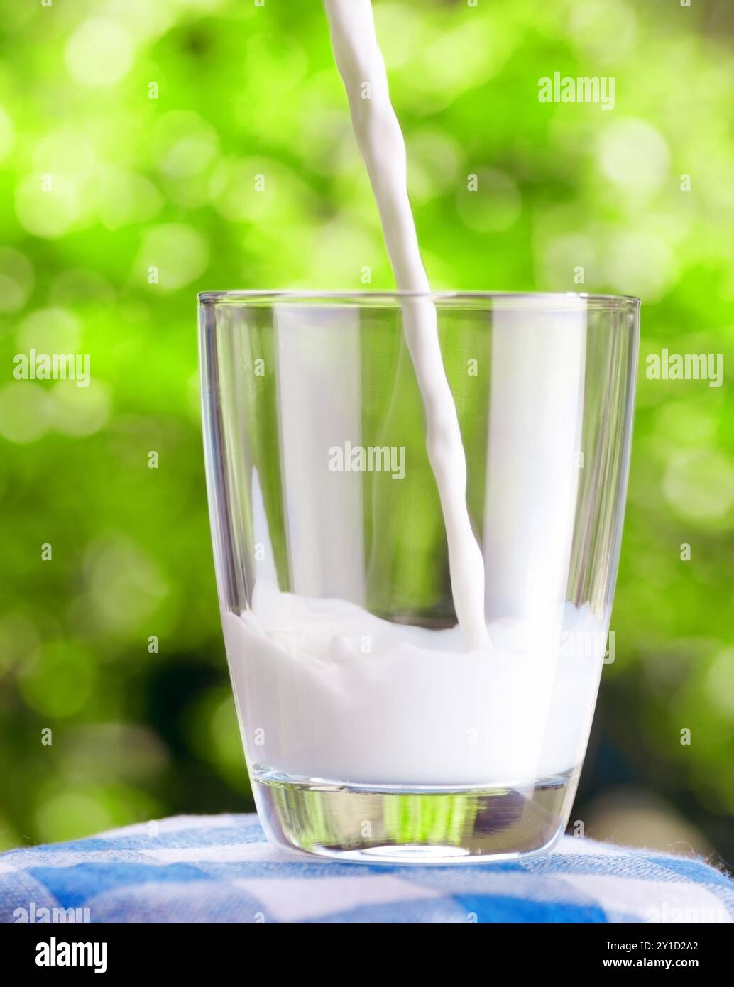 Glass of milk on nature background Stock Photo - Alamy
