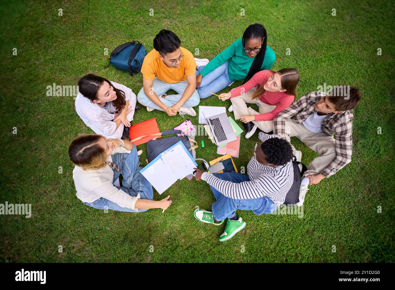 View above group diverse Gen z university students going through ...
