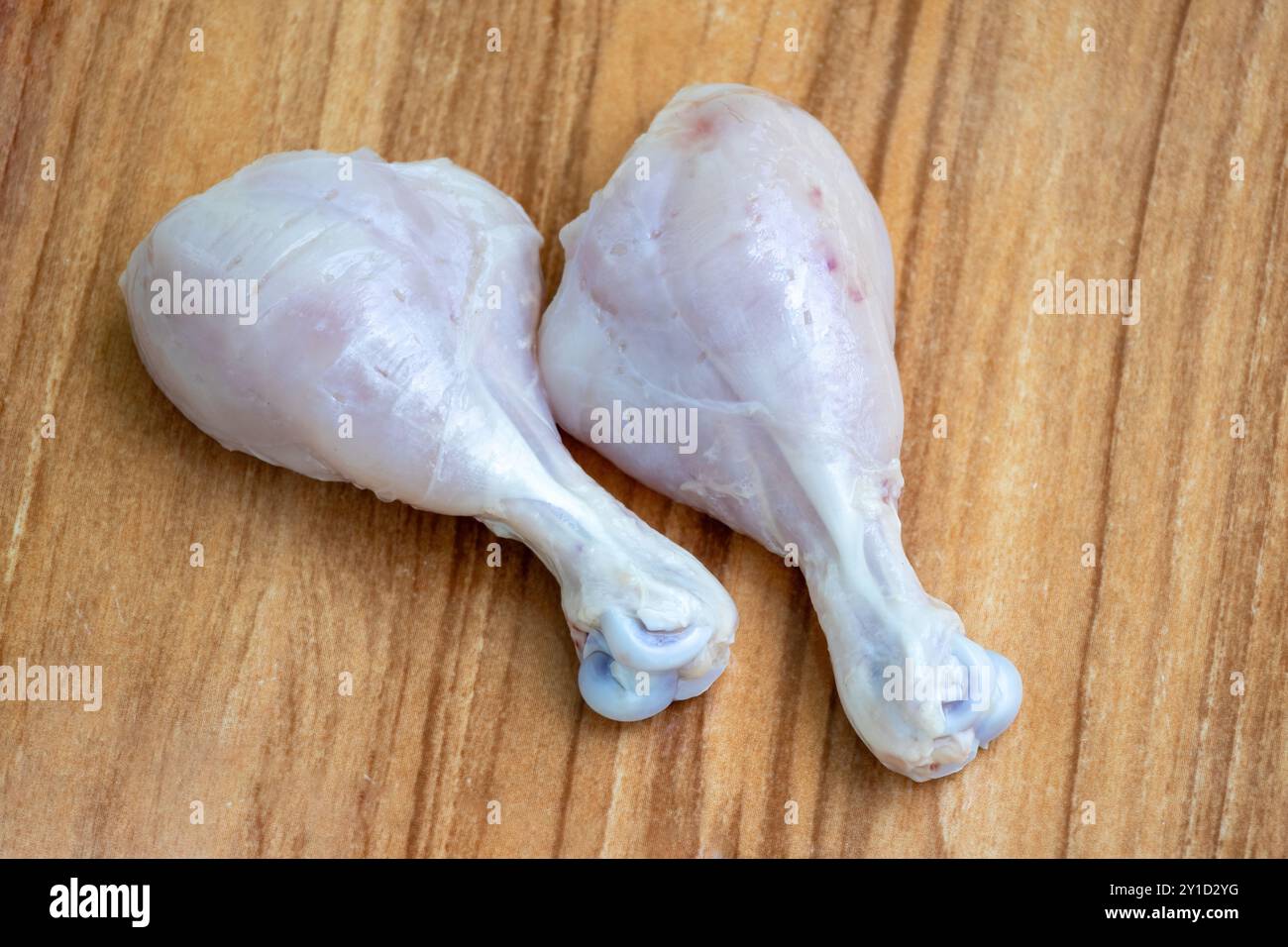 Raw chicken legs on wooden board Stock Photo - Alamy