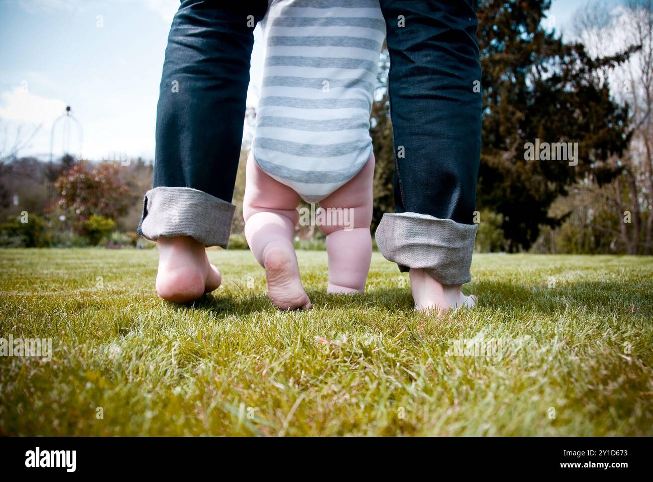 Baby first steps. Shot from behind, legs only Stock Photo - Alamy