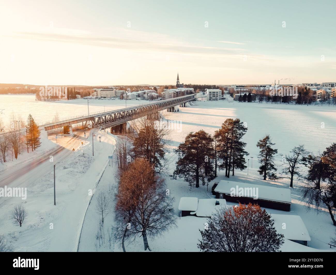 Aerial view of frozen river through Rovaniemi with bridge in Lapland ...