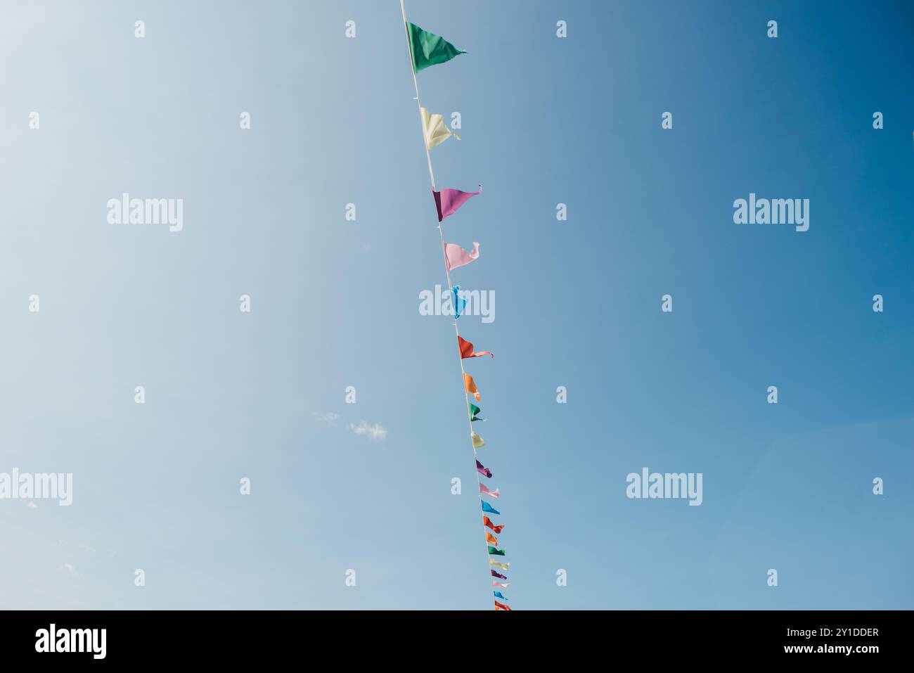 Bunting flying in the sky under blue sky and sun Stock Photo - Alamy