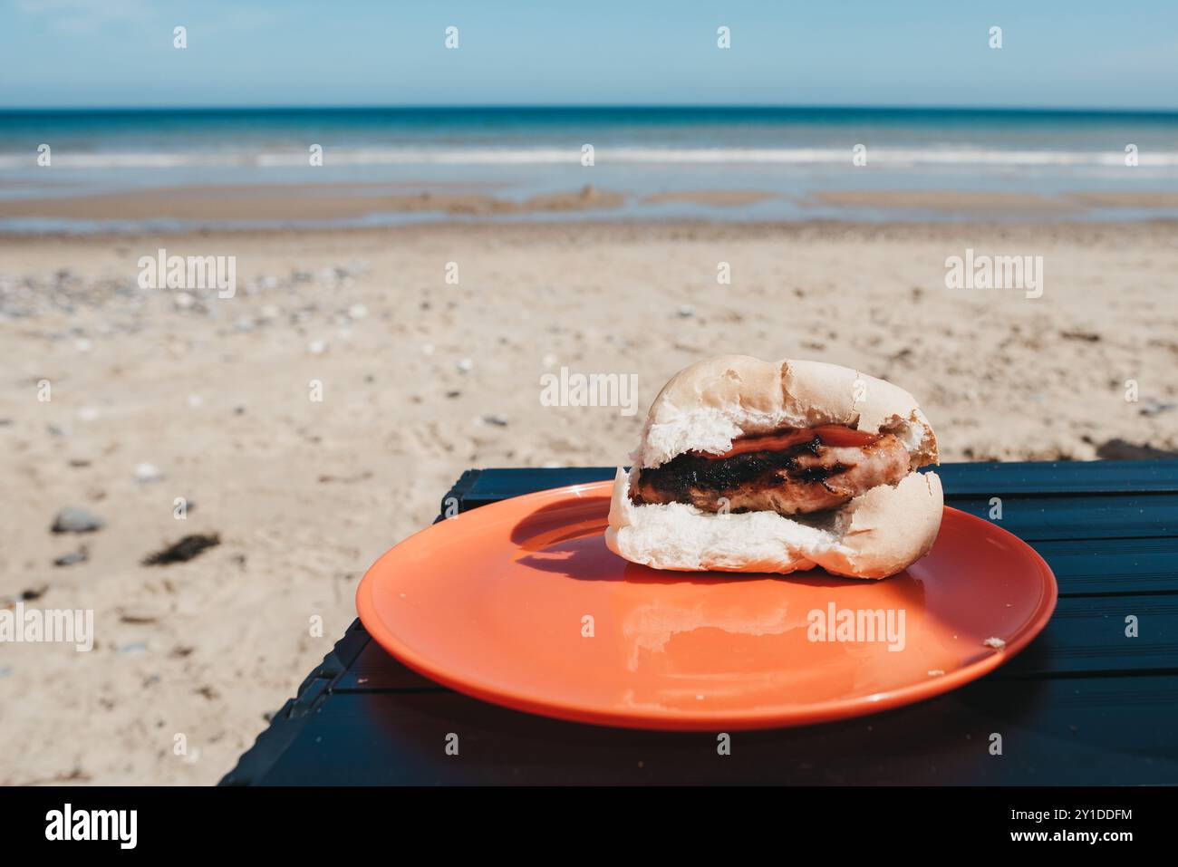 Beach Breakfast, Sausage with Ketchup in a white roll Stock Photo - Alamy