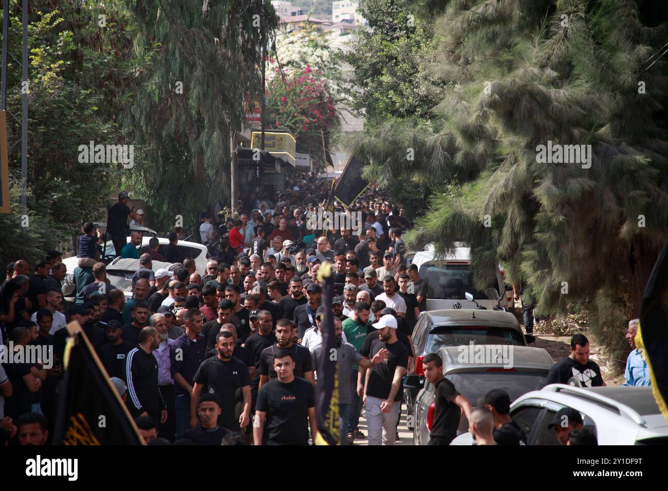 Mourners carry the bodies of Palestinians killed during an Israel raid ...