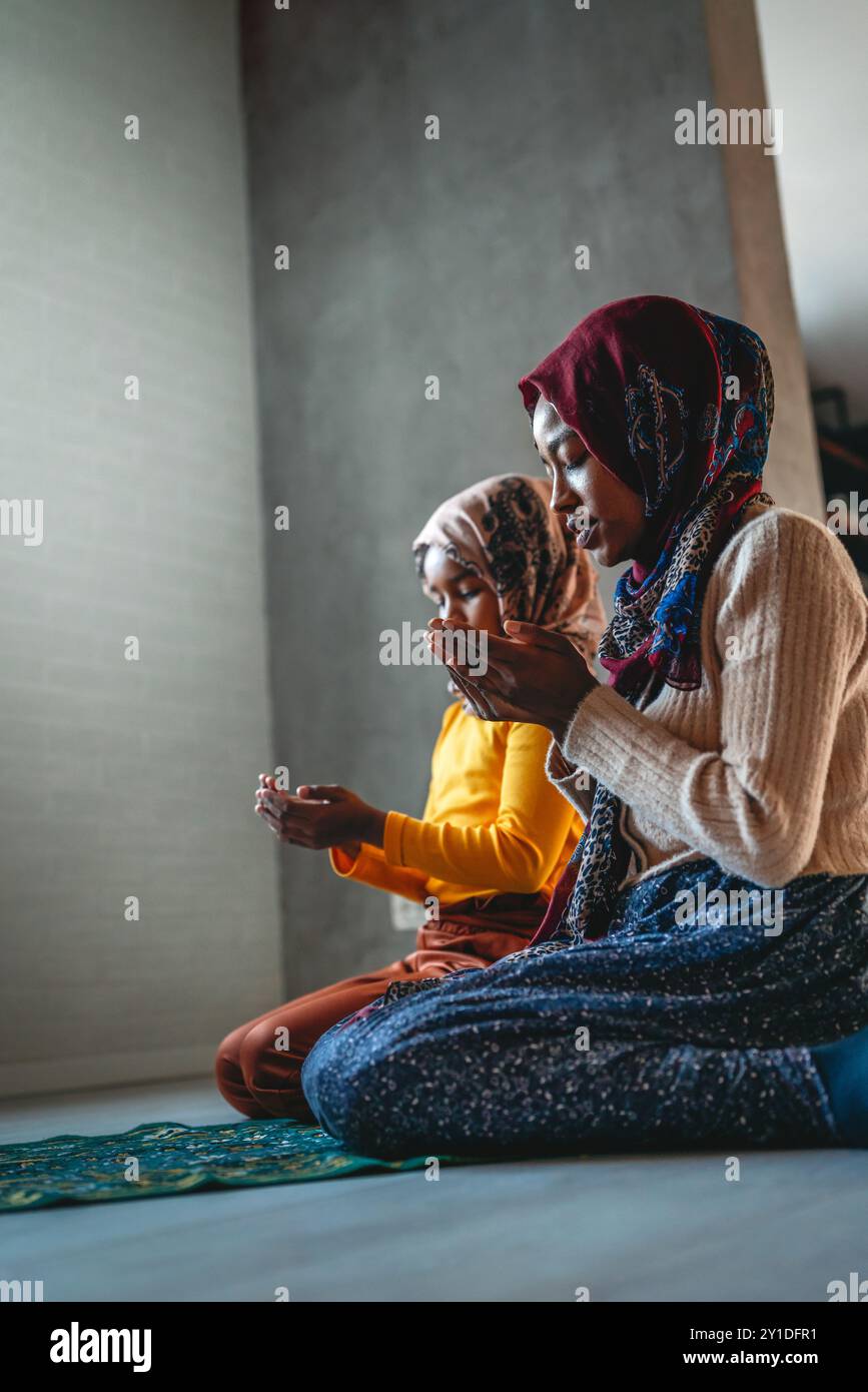 Beautiful muslim mother and child performing islamic prayers Stock ...