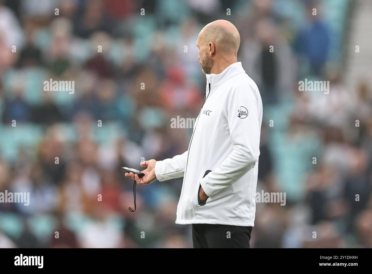 Reserve umpire Michael Burns checks the light after lu nah as poor ...