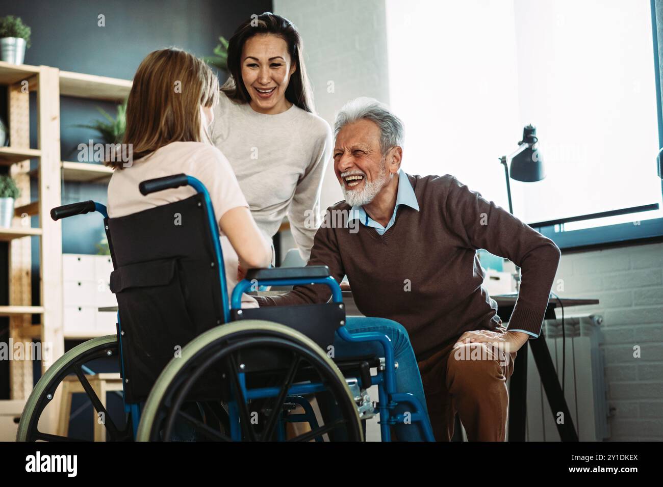 Happy multiethnic family with child with disability in wheelchair Stock ...