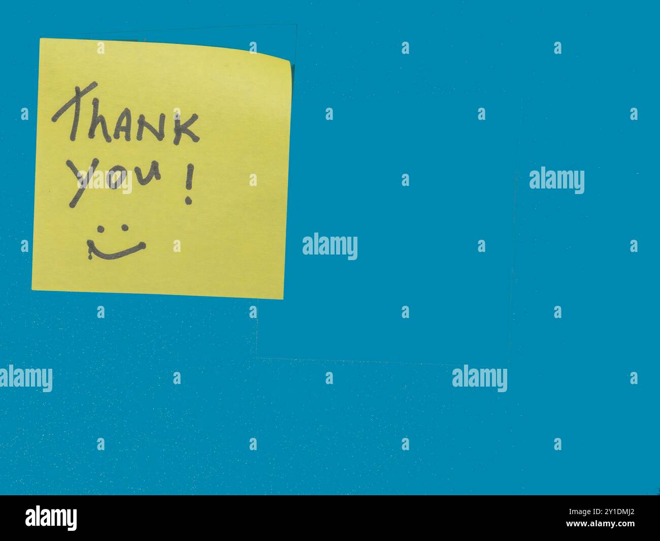 Yellow Thank You Post-it Note with a smiley face on a blue background ...