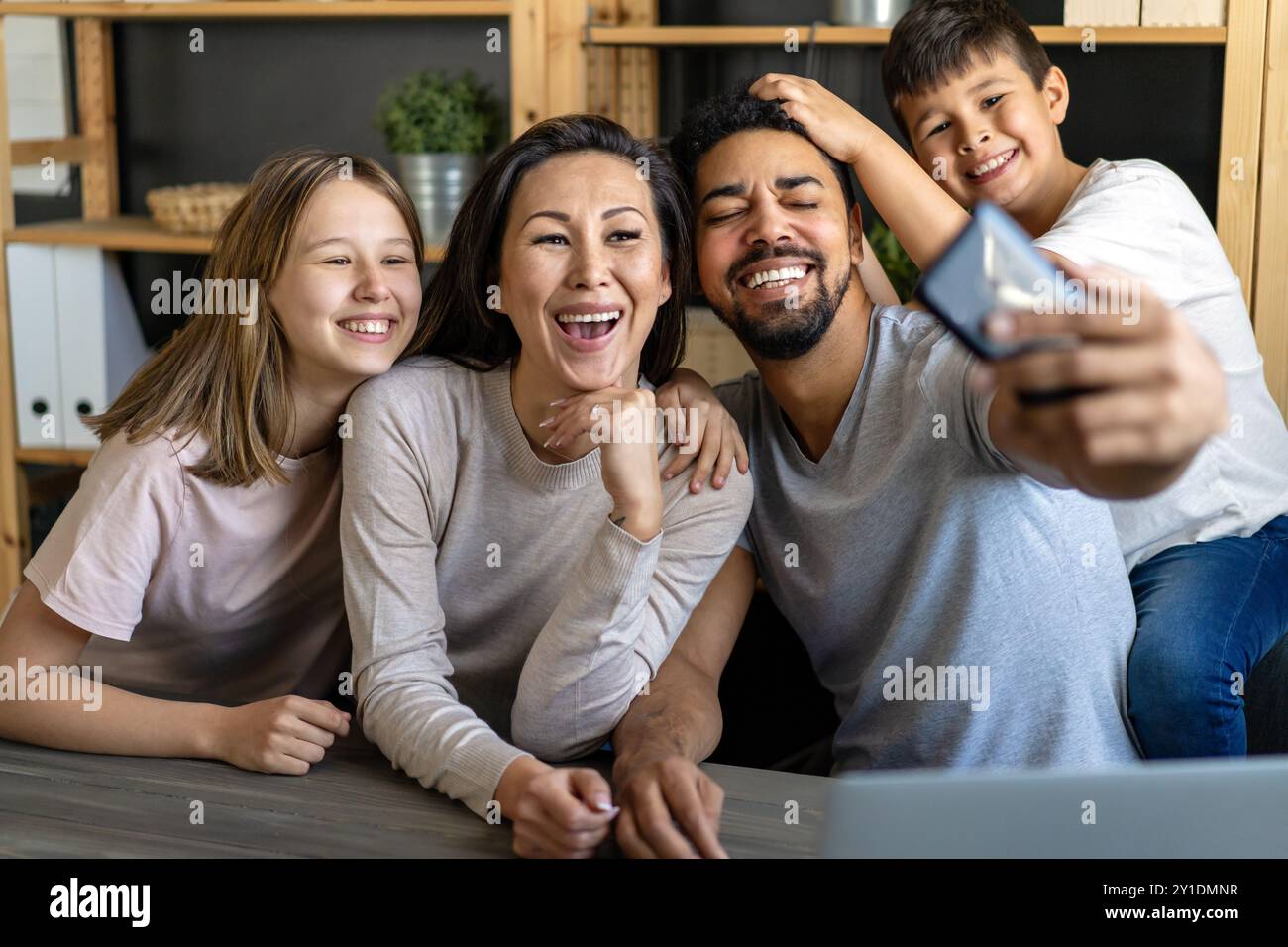 Happy multiethnic family. Mixed race parents with children taking ...