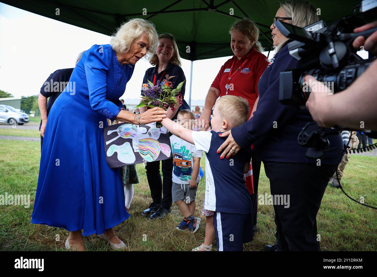 Queen Camilla, Honorary Air Commodore, is presented flowers from local ...