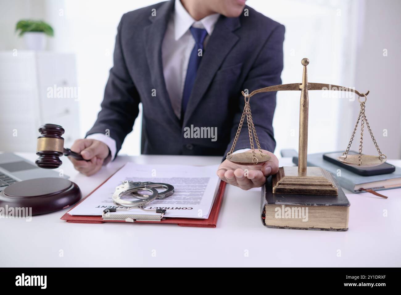 a brass scale is placed on a table in a lawyer office as a decoration ...