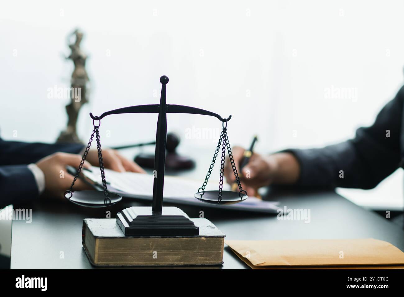 a brass scale is placed on a table in a lawyer office as a decoration ...