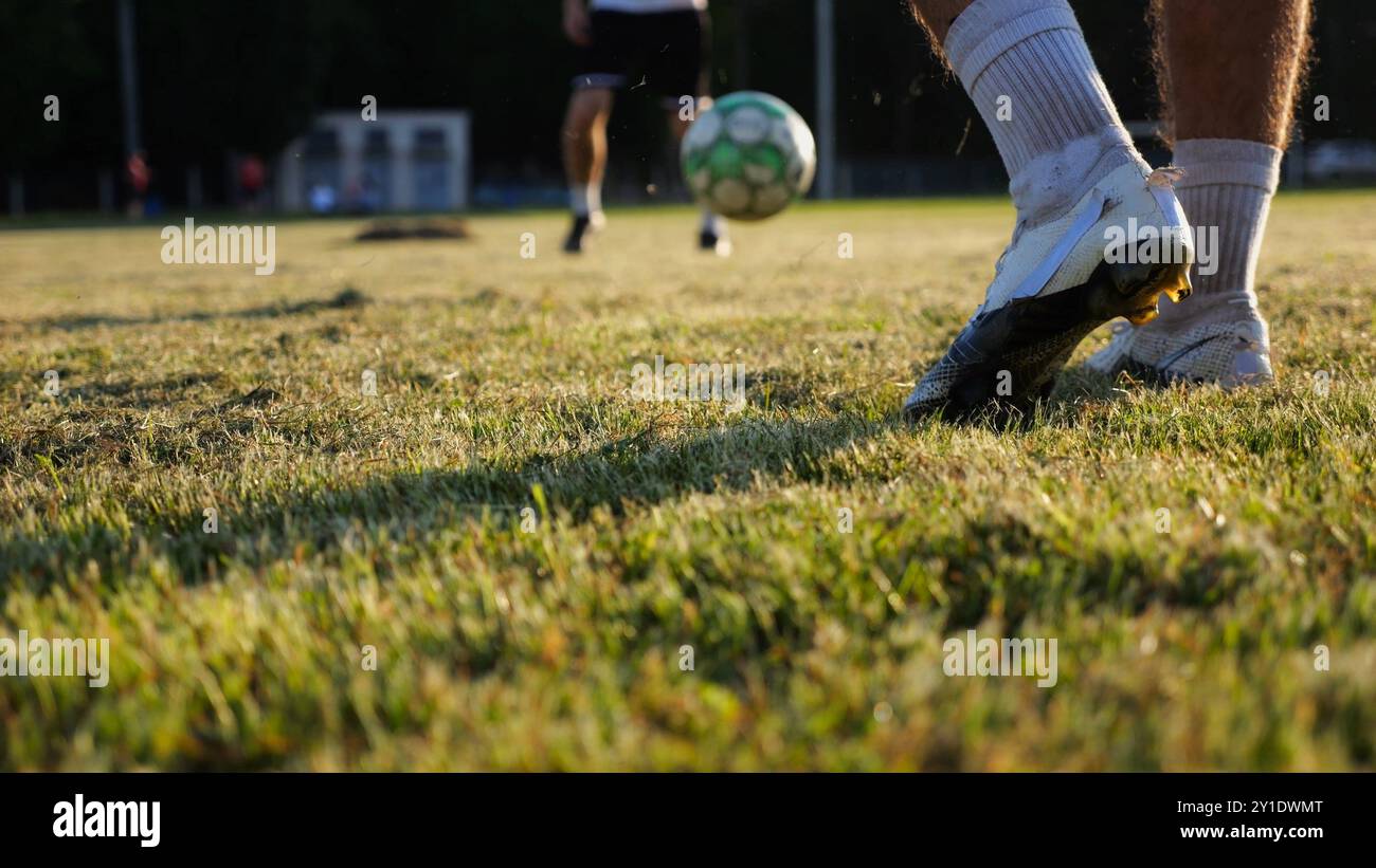 Male feet of professional footballers passing soccer ball on stadium at ...