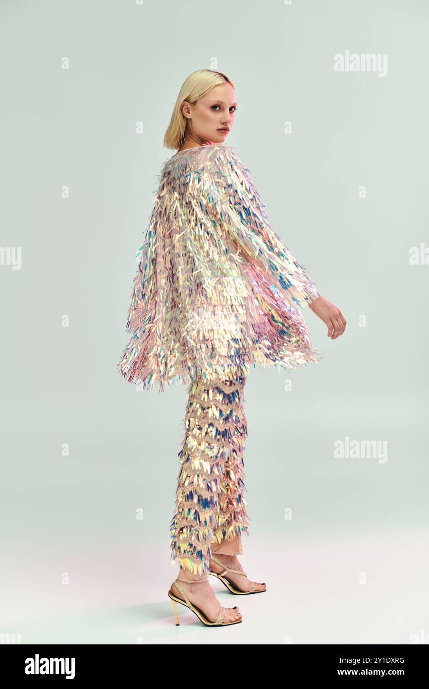 A young woman poses elegantly in luminous, trendy attire with ...