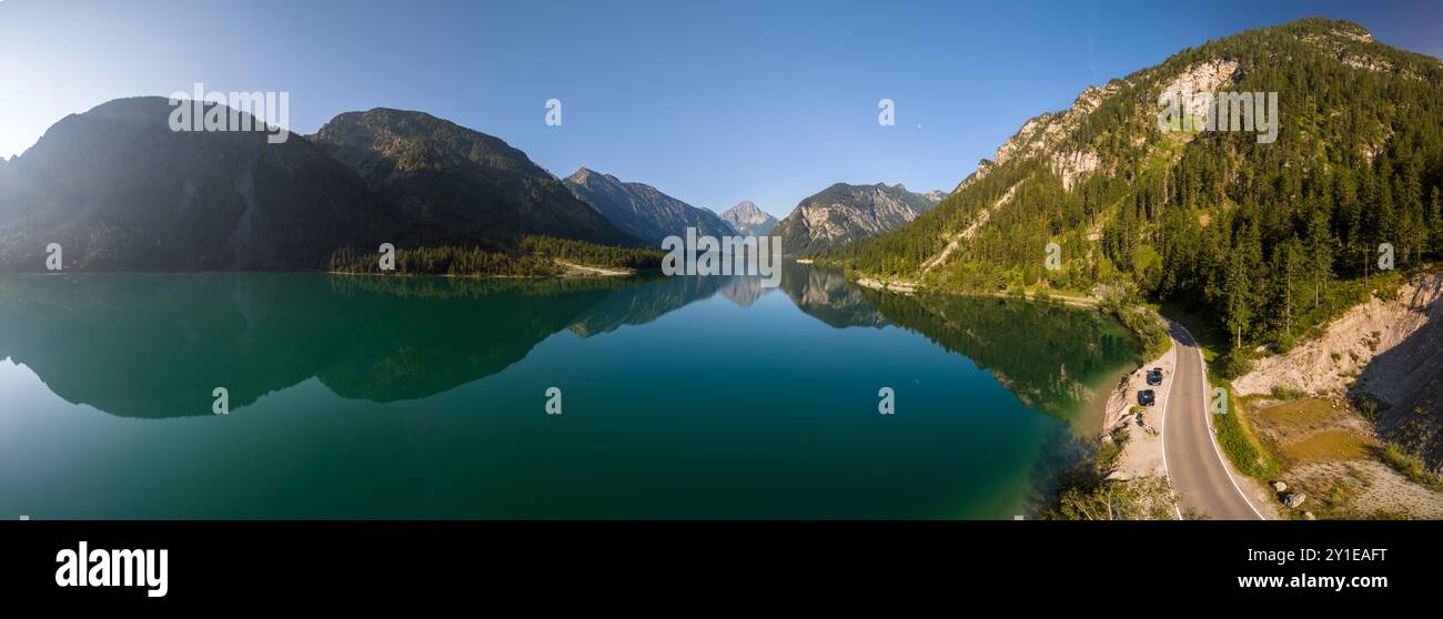 The tranquil waters of Plansee Austria reflect the surrounding mountain ...