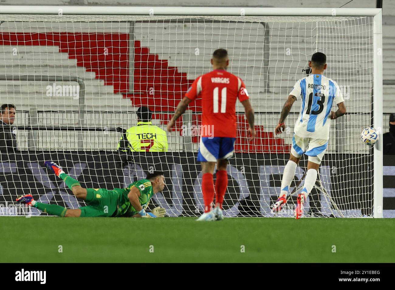 Argentina's goalkeeper Emiliano Martinez (L) eyes the ball hit the goal ...