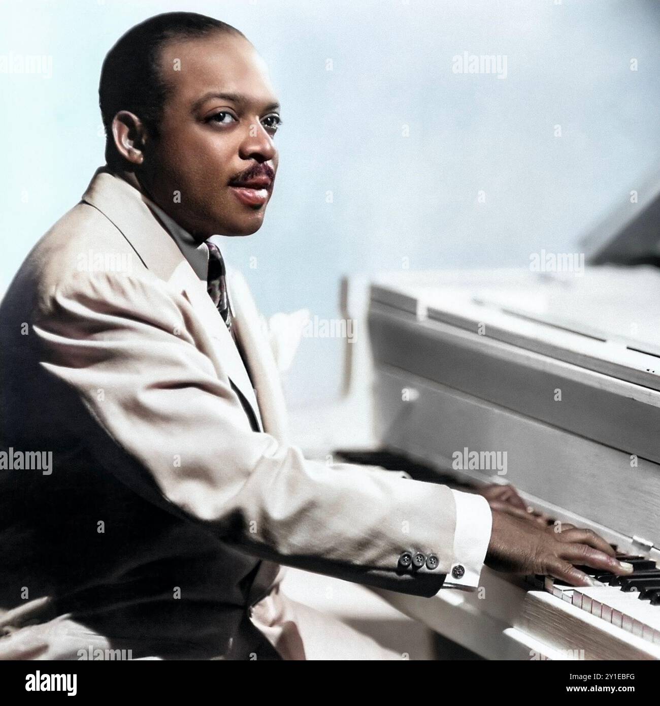 Portrait of American jazz bandleader and pianist Count Basie, seated at ...