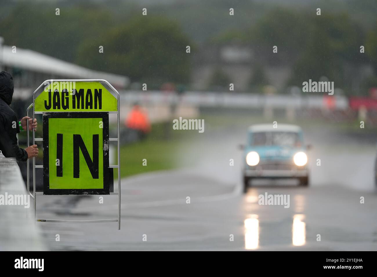 Goodwood Revival, immersive sport event. Jag Man In sign instructs a ...